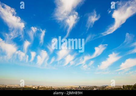 Flying cirrus clouds over blooming land Stock Photo - Alamy