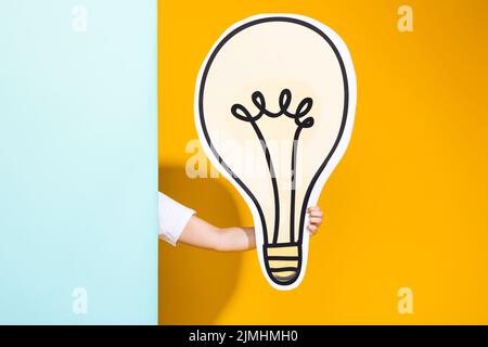 Portrait schoolgirl with big light bulb Stock Photo - Alamy