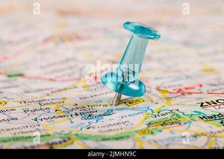 Turquoise colored pushpin stucked world map Stock Photo - Alamy