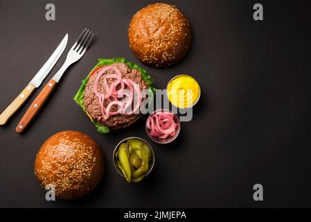 Top view beef burger with sauces cutlery Stock Photo - Alamy