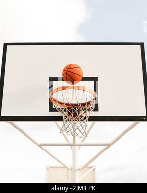 Low angle of a basketball hoop under the gray sky Stock Photo - Alamy