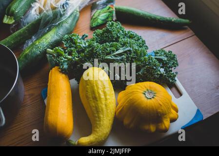 Squash and collard greens on a cutting board Stock Photo - Alamy