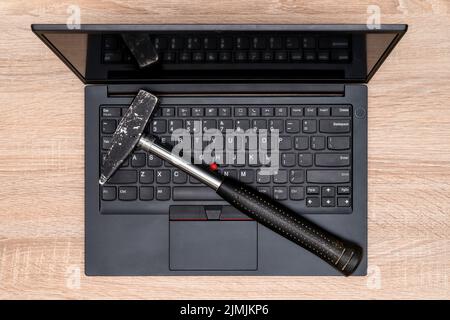 Hammer placed on laptop keyboard Stock Photo - Alamy