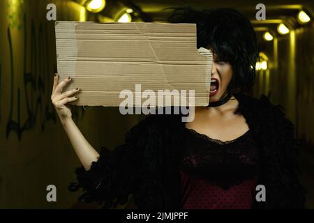 Strange and freaky woman with a piece of blank cardboard Stock Photo ...