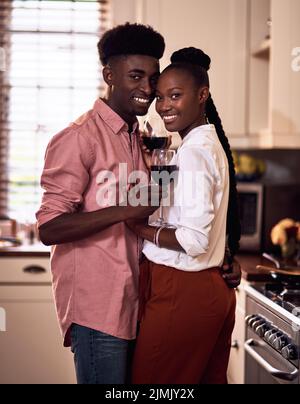Smiling young man holding valentines heart cutout and looking at camera ...