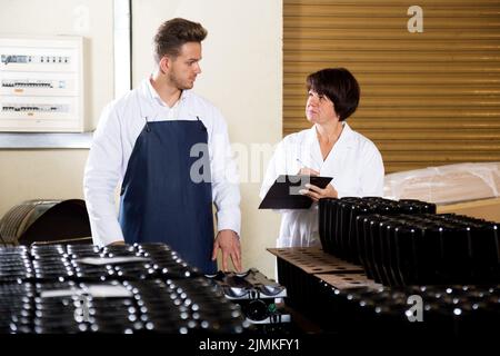 Employees checking number of wine bottles Stock Photo - Alamy