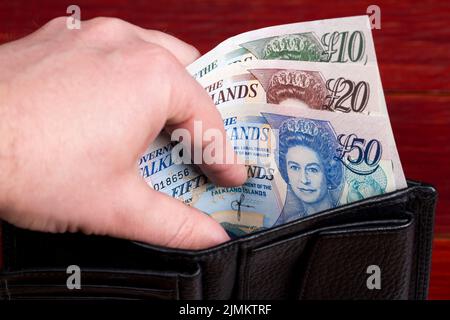 Falkland Islands pounds in the black wallet Stock Photo - Alamy