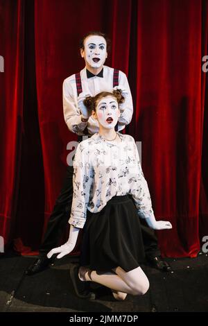 Male mime artist placing his hand female mime s hair buns Stock Photo ...