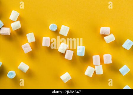 Orange background with colourful marshmallows Stock Photo - Alamy