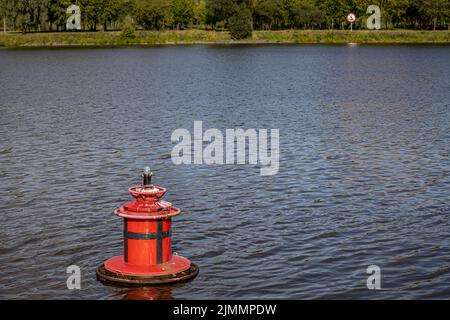 red floating lighthouse on the surface of the water. High quality photo ...