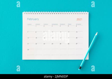 Flat lay planner calendar blue background Stock Photo - Alamy