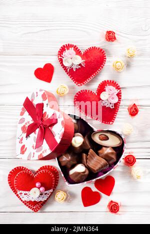 Chokolate box in shape of heart on white wooden table valentine ...
