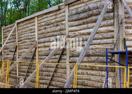 Traditional wooden house peeled log wall during cobntruction process ...