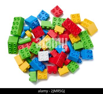 Scattered parts of a plastic children's designer, top view. White ...