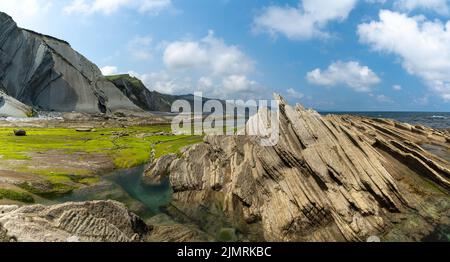 A panorama view of the Flysch rock formations and cliffs with tidal ...
