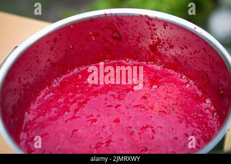 The process of making redcurrant sauce. Top view grated red currant ...