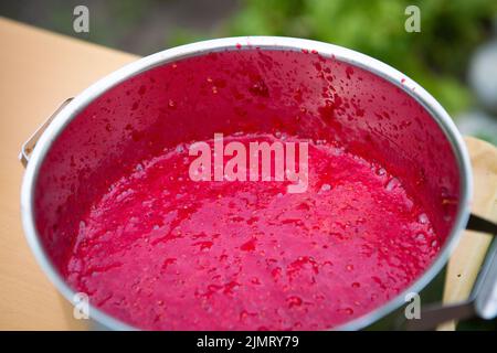 The process of making redcurrant sauce. Currant berries and spices are ...