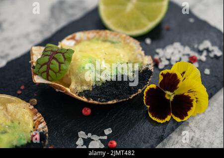 Delicacy roasted scallops with cheese spices and chuka algae Stock ...