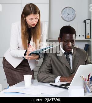 Woman writing down chiefs tasks Stock Photo - Alamy