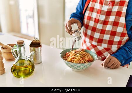 Man pouring salt on plate of food Stock Photo - Alamy