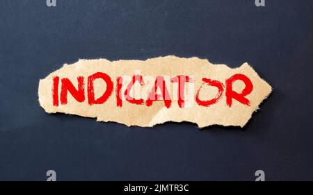 INDICATOR - word on a notebook on a light wooden background with a ...