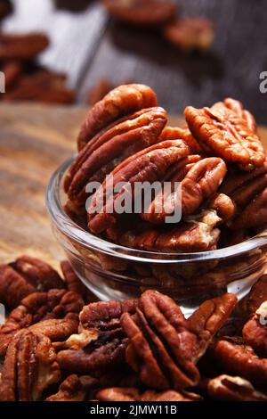 Composition with a bowl of shelled pecan nuts. Delicacies Stock Photo ...