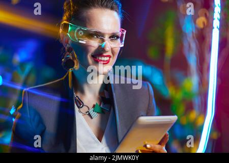 trendy female with futuristic goggles and tablet PC in metaverse Stock ...