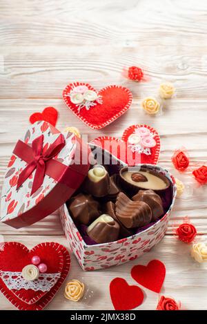 Chokolate box in shape of heart on white wooden table valentine ...