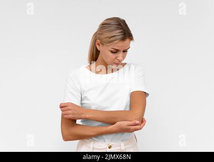 Front view woman with elbow pain Stock Photo - Alamy