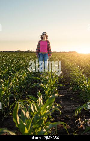 Female caucasian maize farmer with tablet computer inspecting stalks at ...