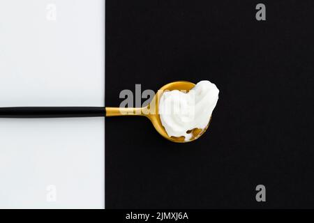 Whipped cream golden spoon Stock Photo - Alamy