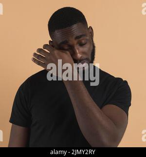 Person wiping away his tears Stock Photo - Alamy