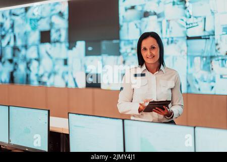 Portrait of female security operator while working in a data system ...