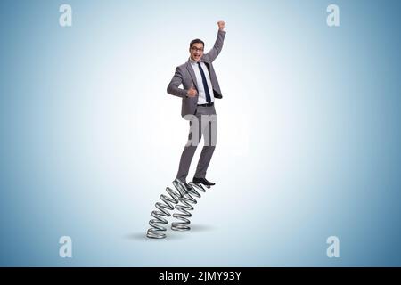 Businessman jumping high on the springs Stock Photo - Alamy