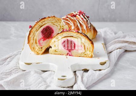 Croissant cut in half, showing the cross section with raspberry ...