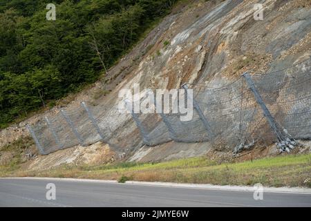Active robust rockfall barrier system with wire mesh along the road ...