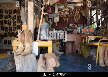 Local shoe shop. Shoe production workshop. Portrait of the shoemaker ...