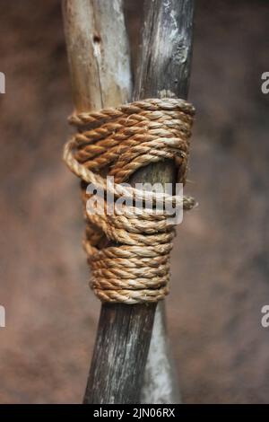 Two branches tied tied together with rope Stock Photo - Alamy