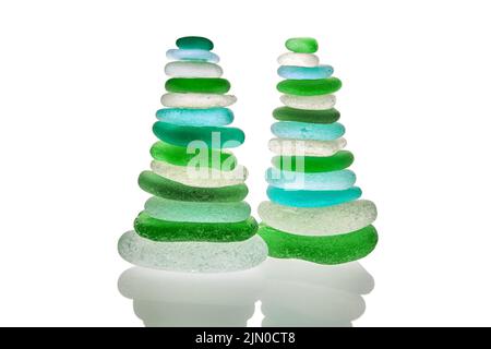 Pyramid of balanced sea-polished multicolored glass stones on a white ...