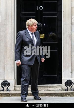 Prime Minister Boris Johnson stands outside 10 Downing Street in London ...