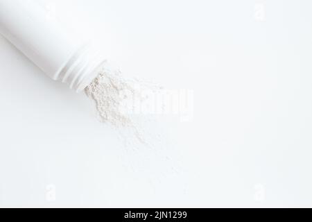 Talcum powder in container. Spilled white powder Stock Photo - Alamy
