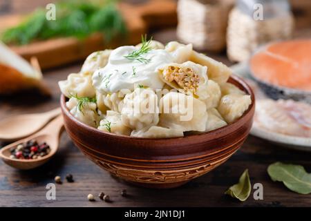 Russian dumplings with potato in white enamel bowl Stock Photo - Alamy