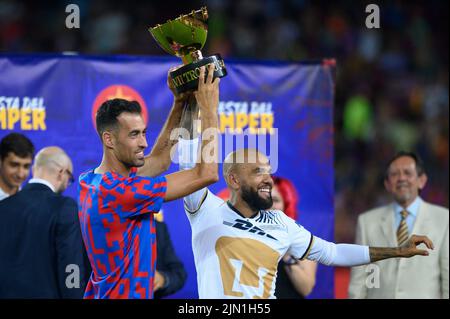 Dani Alves of Pumas UNAM and Sergio Busquets of FC Barcelona during the ...