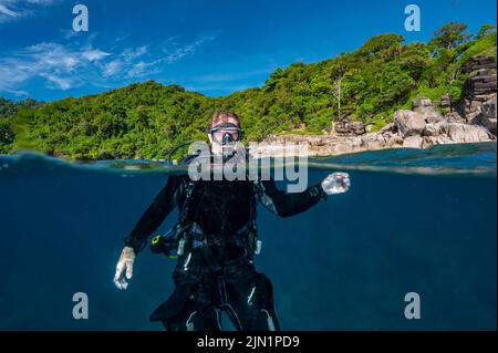diver surfaces in the tropical waters of the Andaman Sea Stock Photo ...