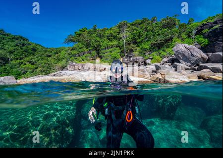 diver surfaces in the tropical waters of the Andaman Sea Stock Photo ...
