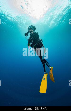 Diver emerging into the tropical waters of the Andaman Sea Stock Photo ...