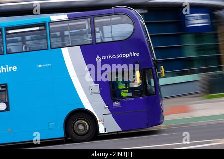 A moving double decker bus operated by Arriva, seen driving through ...