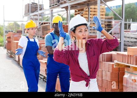 Portrait of surprised employees working in a warehouse Stock Photo - Alamy