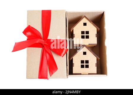 Two wooden toy houses inside a small shipping box. Creative moving in ...