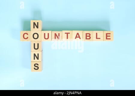 Noun or nouns concept in English grammar education. Wooden block ...